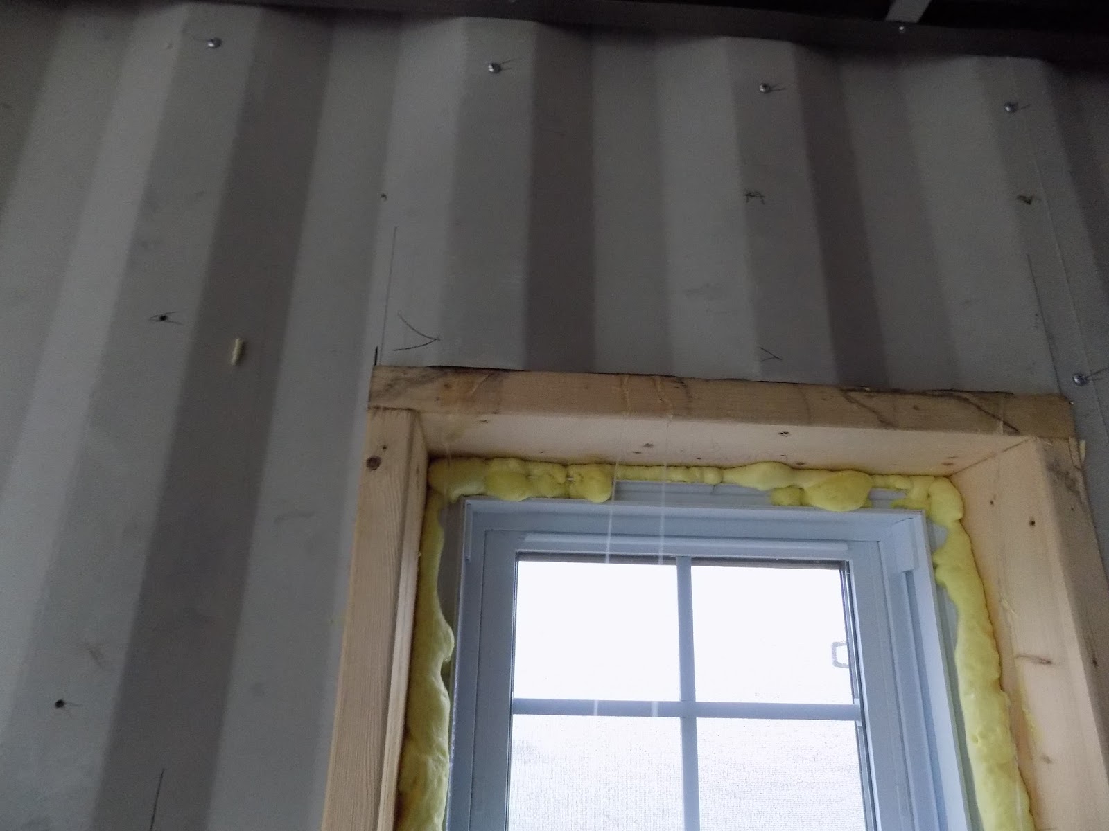 Intermodal House: Strapping on, Windows in, Insulation, Siding Mostly on