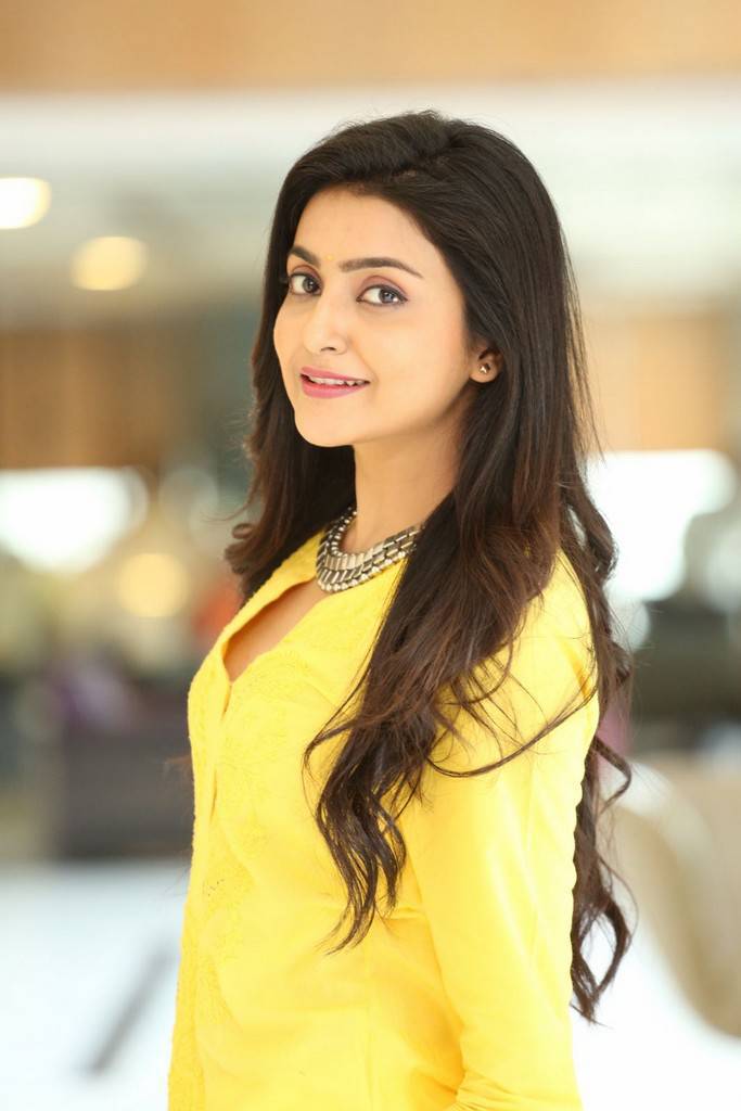 Indian Film Actress Avantika Mishra Long Hair Stills In Yellow Dress