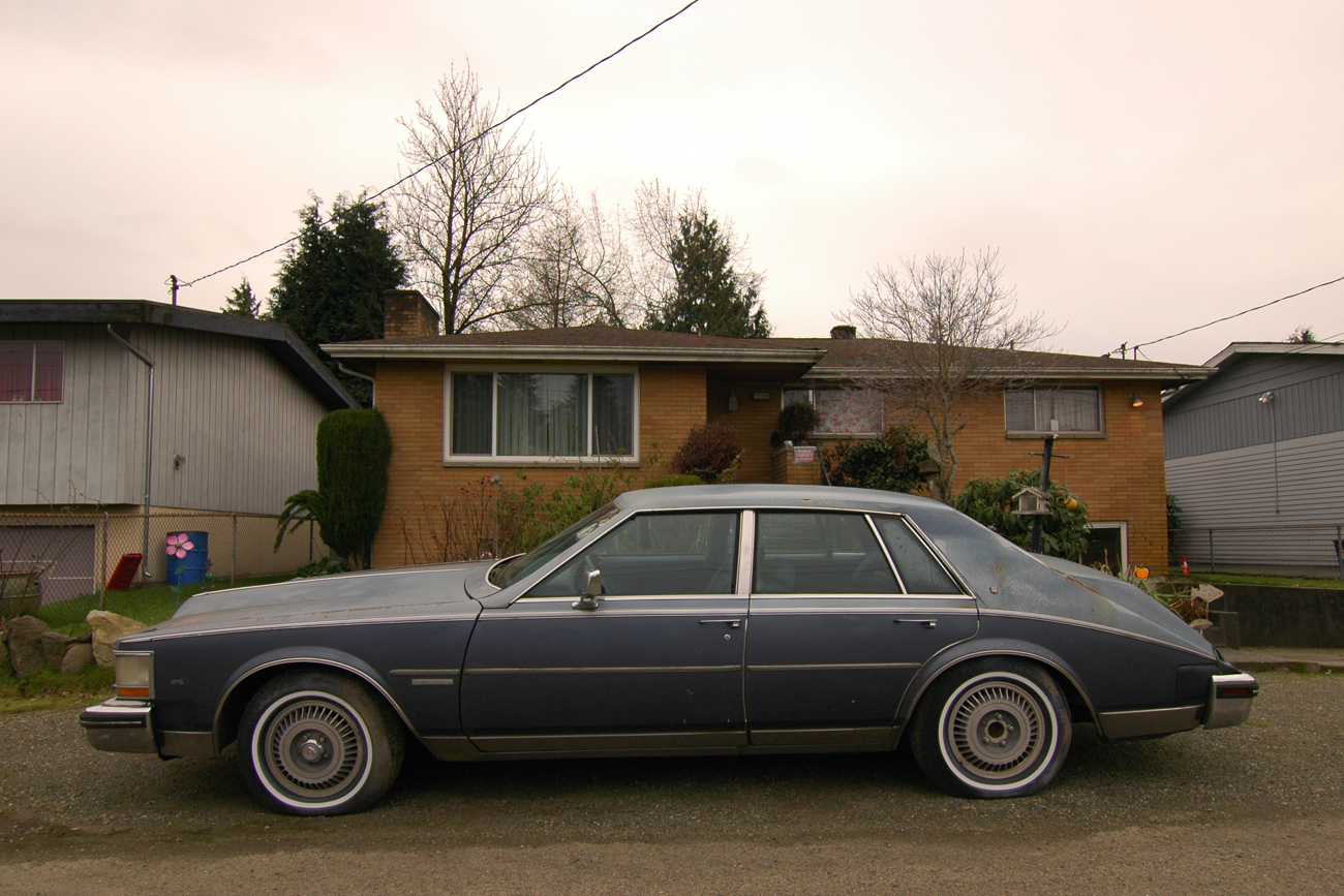 OLD PARKED CARS.: 1983 Cadillac Seville.