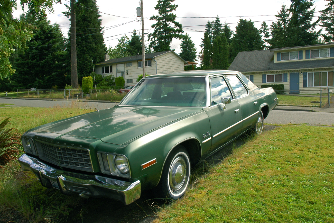 OLD PARKED CARS.: 1976 Plymouth Gran Fury.