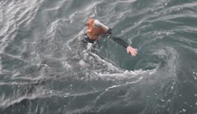 Jacob Cockle seen wearing a horse mask as he moves around the whirlpool ...