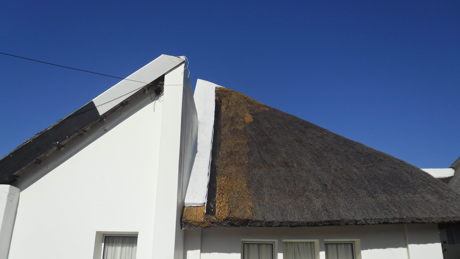 A Solution to Parapet Wall Drainage on Thatch Roofs