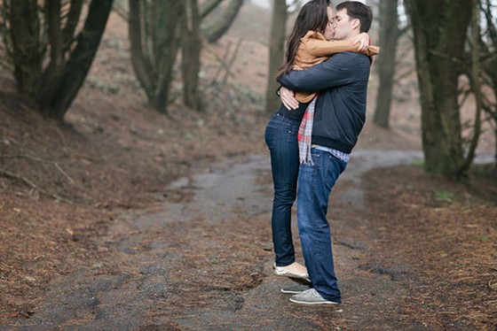 Kissing hug couple lift girl tight hug forest | nineimages