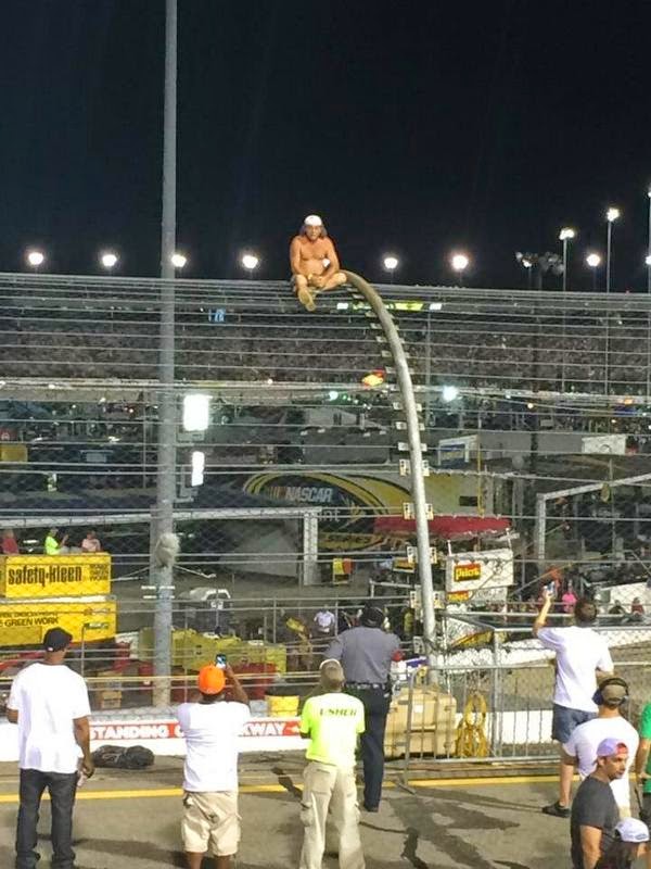 The Mojo News: [Sports] Daredevil fan climbs onto fence at NASCAR race