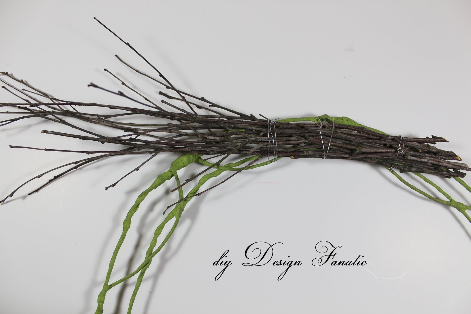 Then, to cover the wire, I hot glued some additional twigs over the wire.