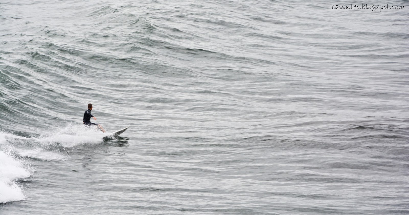 Entree Kibbles: Surfers Surfing on Choppy Waters at Tanah Lot in Bali ...