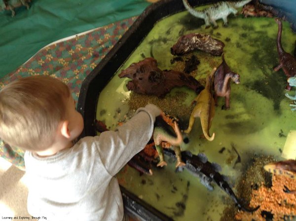 Learning and Exploring Through Play: Dinosaur Sensory Swamp Tuff Tray