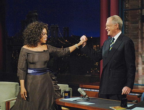 things holding hands with other things: Oprah holding hands with people ...