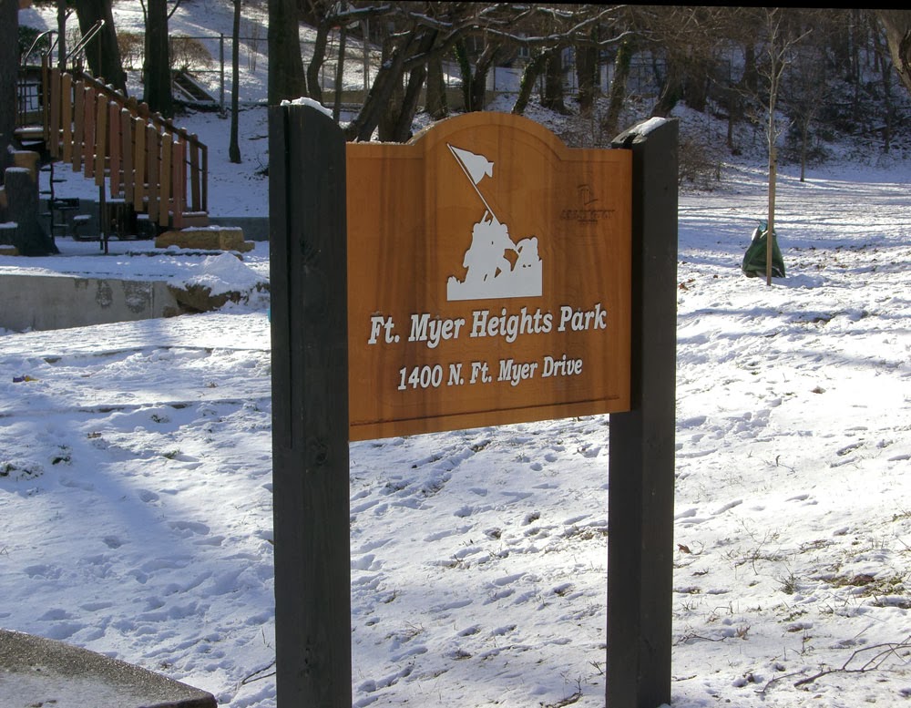 Ode Street Tribune: park sign stands against cold and wind