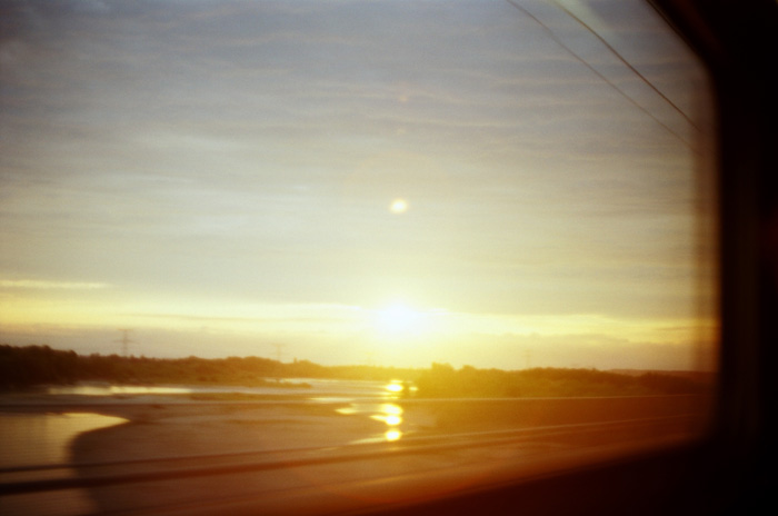 On My Way: Sunset through a train window