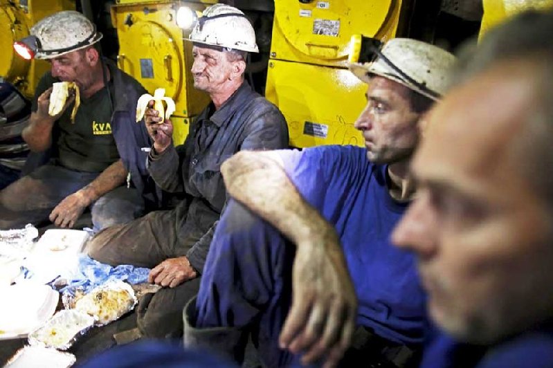 Coal miners eat as they break their fast during the holy month of ...