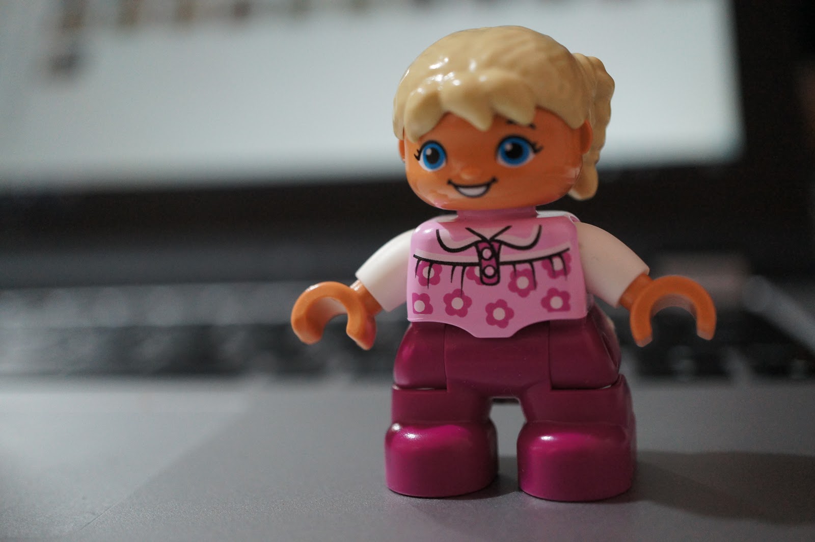 Smiling lady lego on to of a keyboard free picture for commercial use