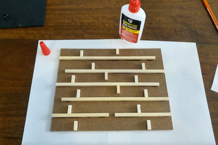 7. Next, add the vertical stiles tightly against the rails.