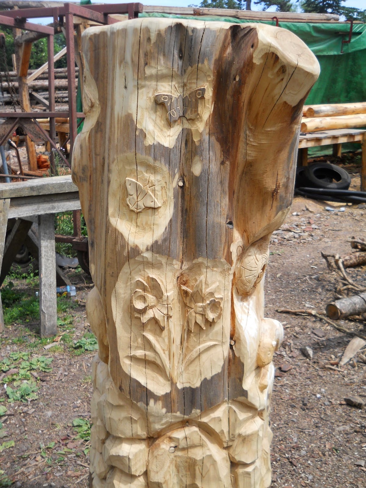 A carved cedar log as a sign for Rock Meadow, a new housing development ...