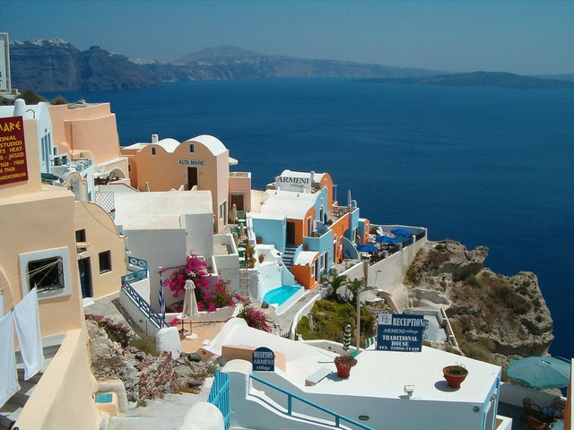 GREEK COLOR: Multi Colored Homes by the deep blue seas of Greece...