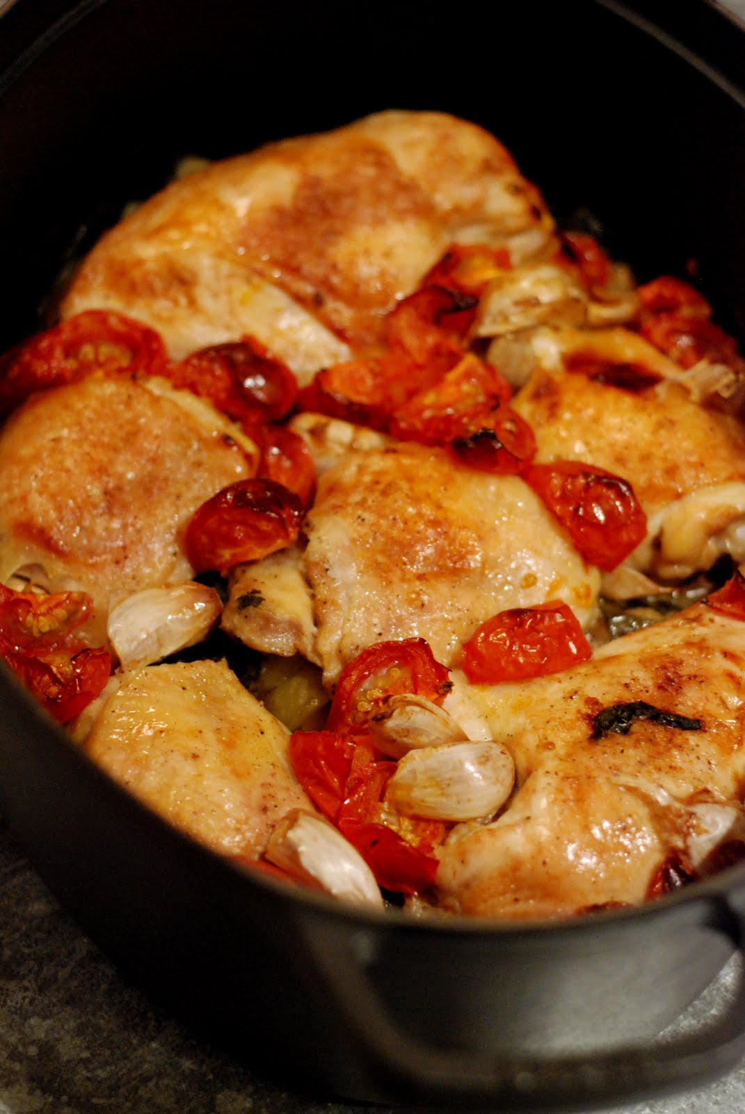 cup and table: roast chicken pieces with sweet tomatoes and garlic