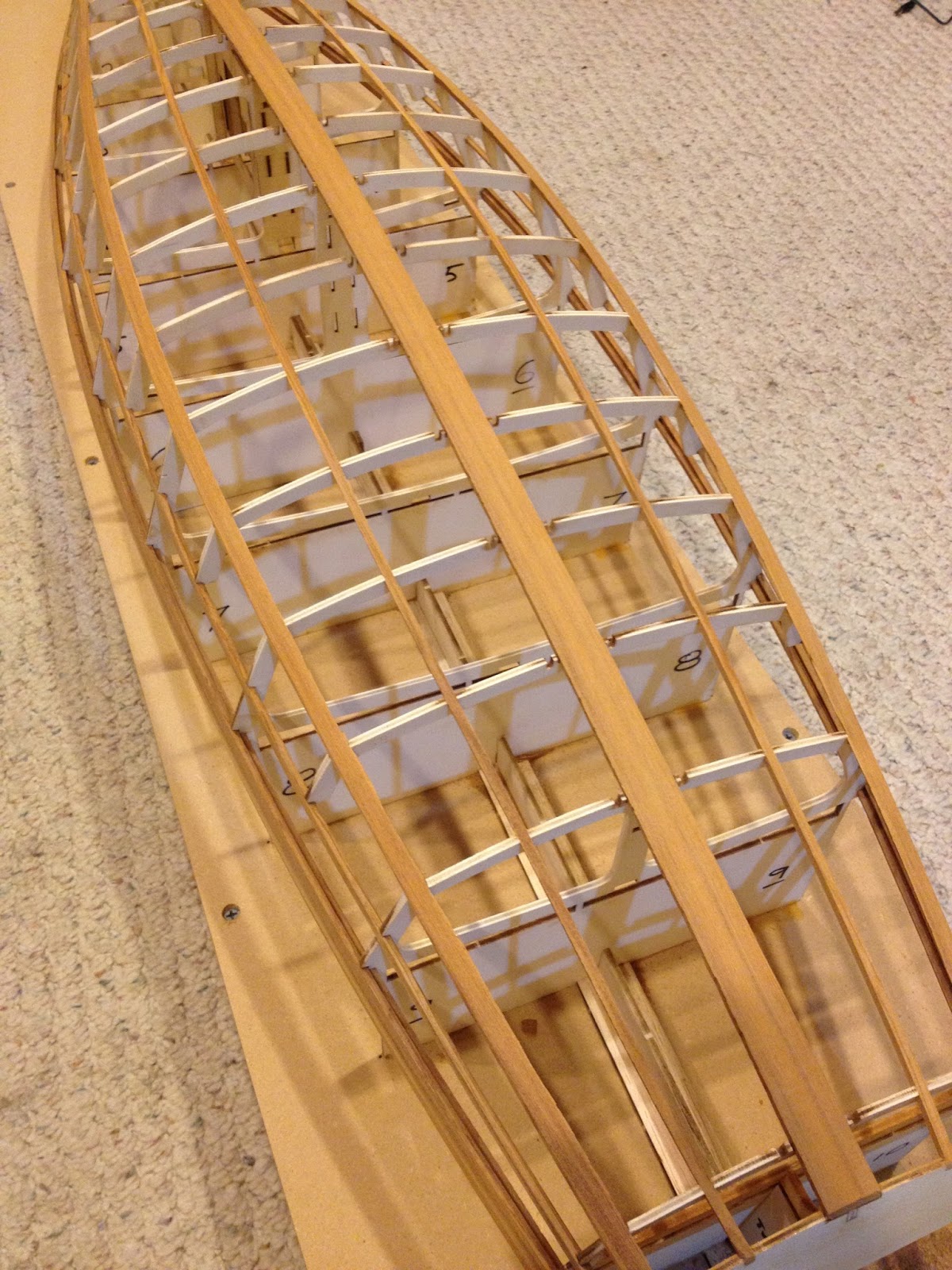 Sheer rails installed and stringers faired