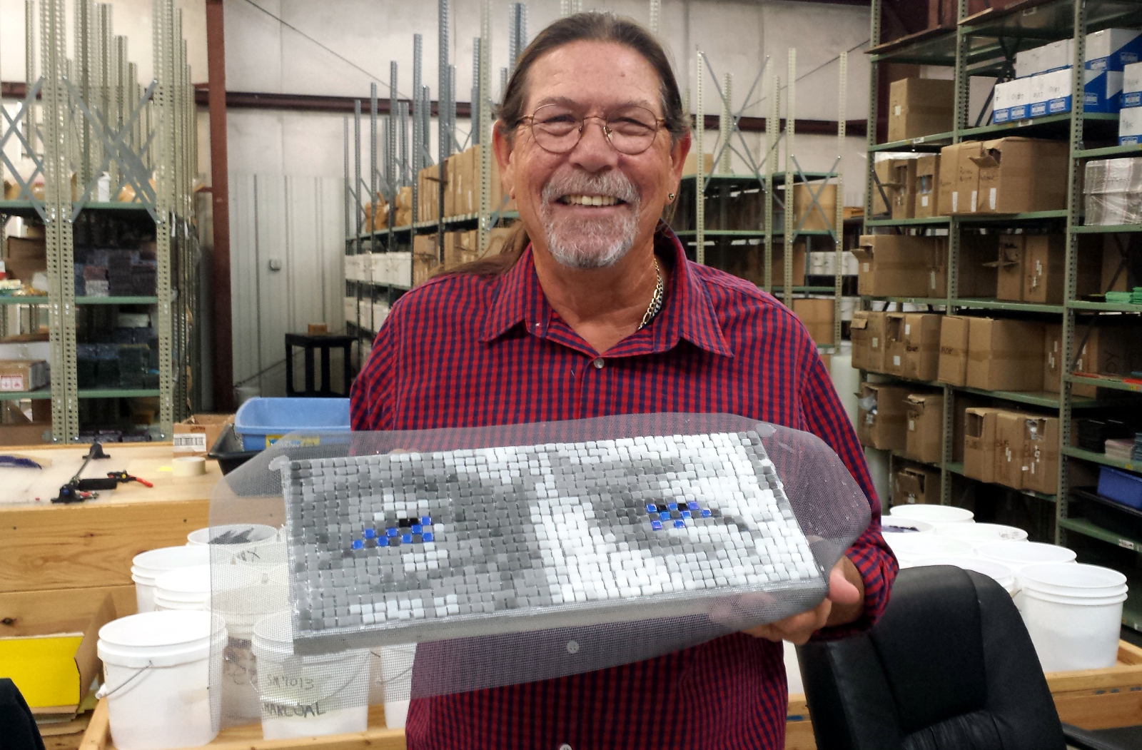 A very happy Daniel showing his mosaic self portrait.