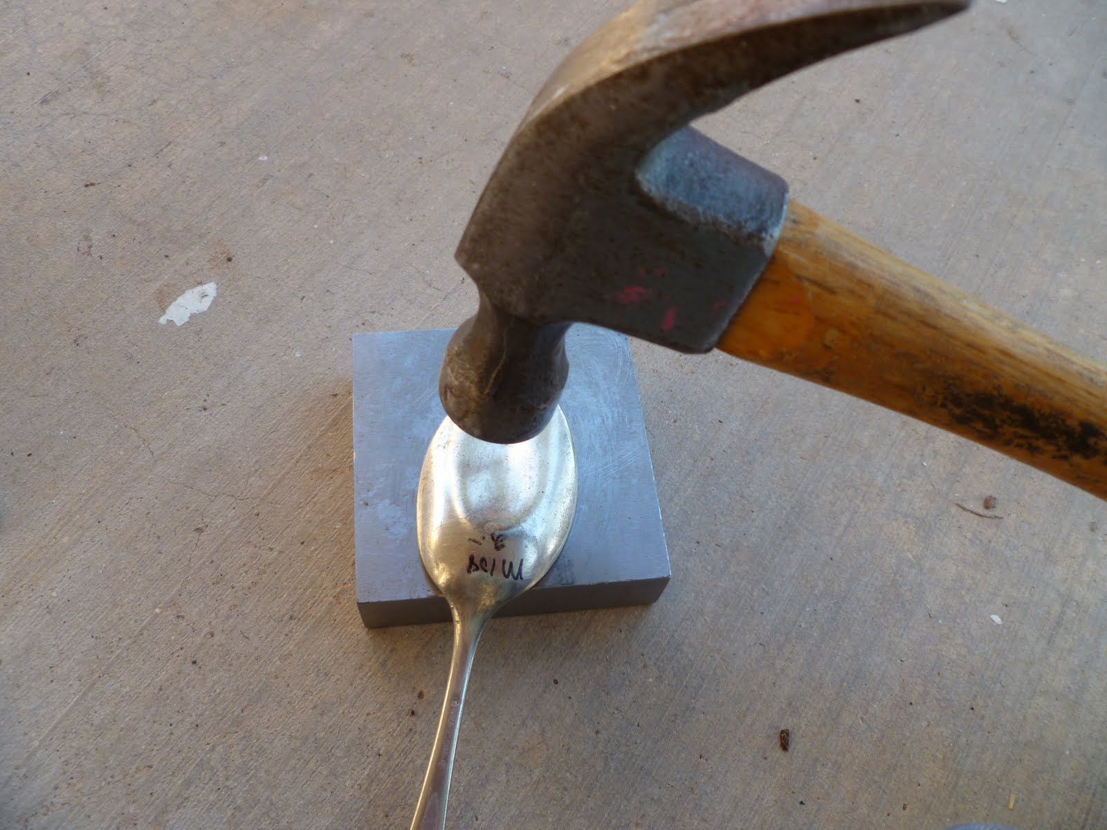 Take a spoon, and hammer it flat. I hammered on a bench block that I ...