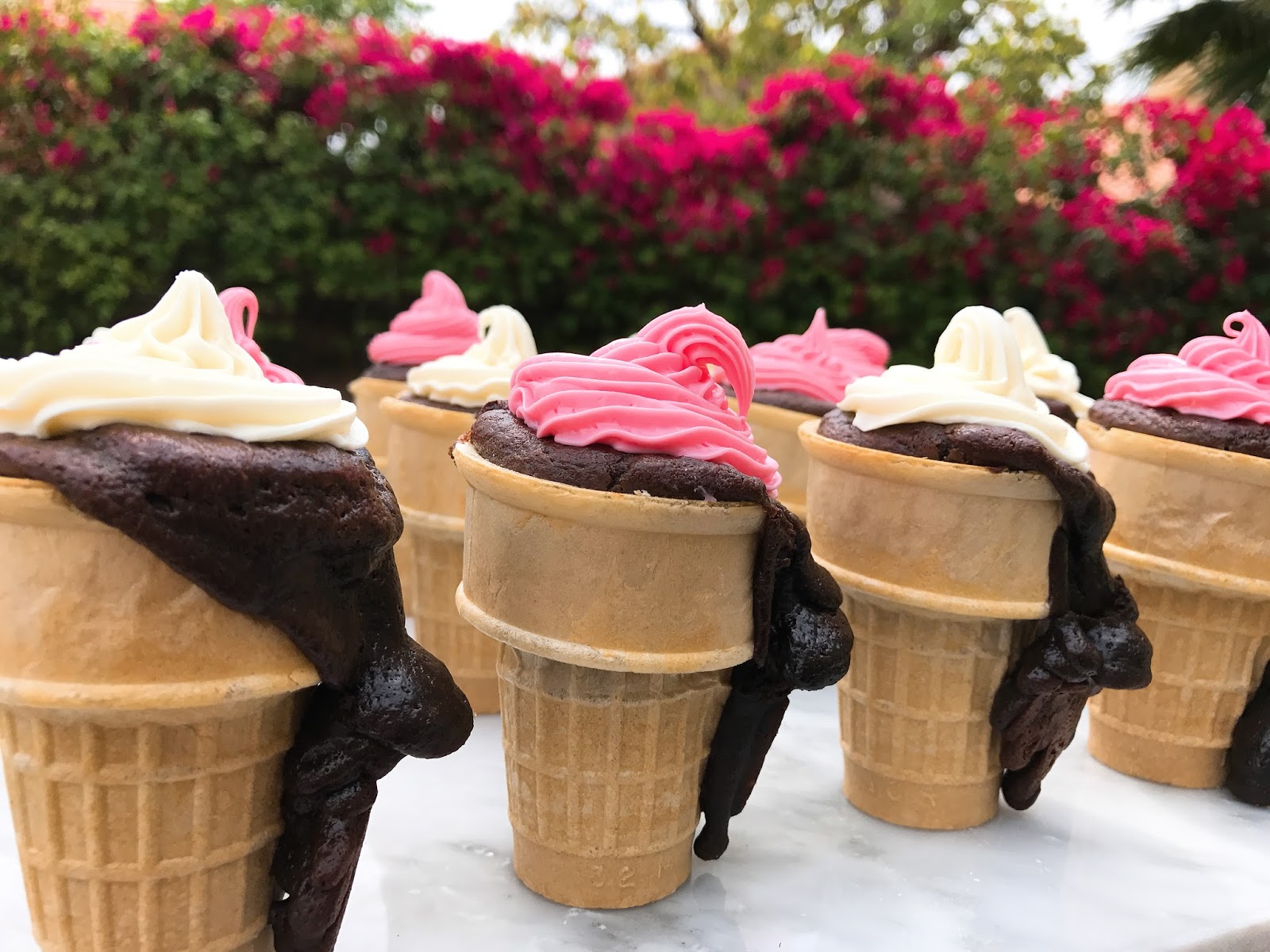 Overflowing Chocolate Cake Cups with Vanilla and Strawberry Icing