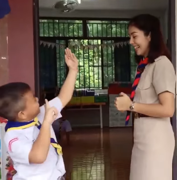 Teacher earns praise for greeting children with special handshake ...