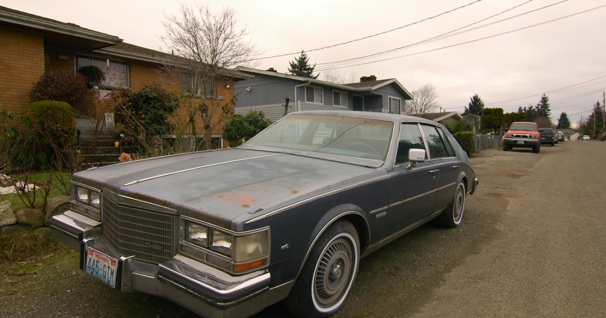 OLD PARKED CARS.: 1983 Cadillac Seville.