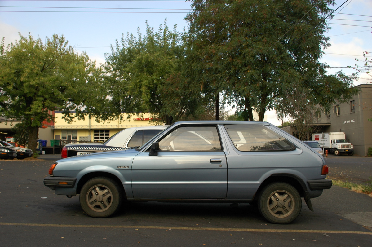 OLD PARKED CARS.: 1985 Subaru STD hatchback.