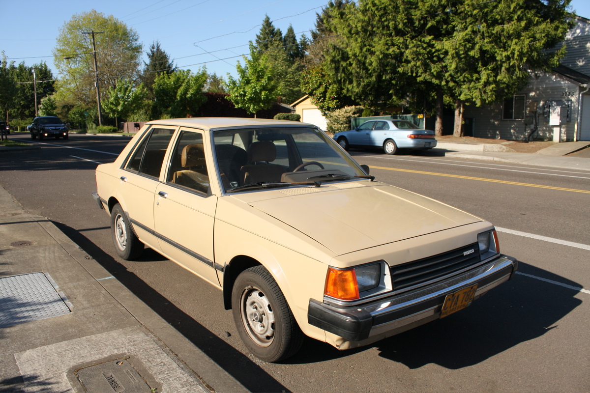 OLD PARKED CARS.: 1982 Mazda GLC Sedan.