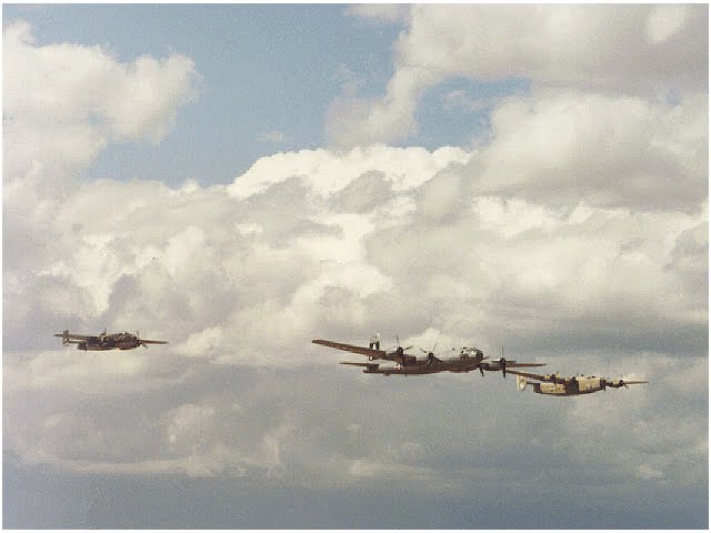 a bomber formation among the clouds
