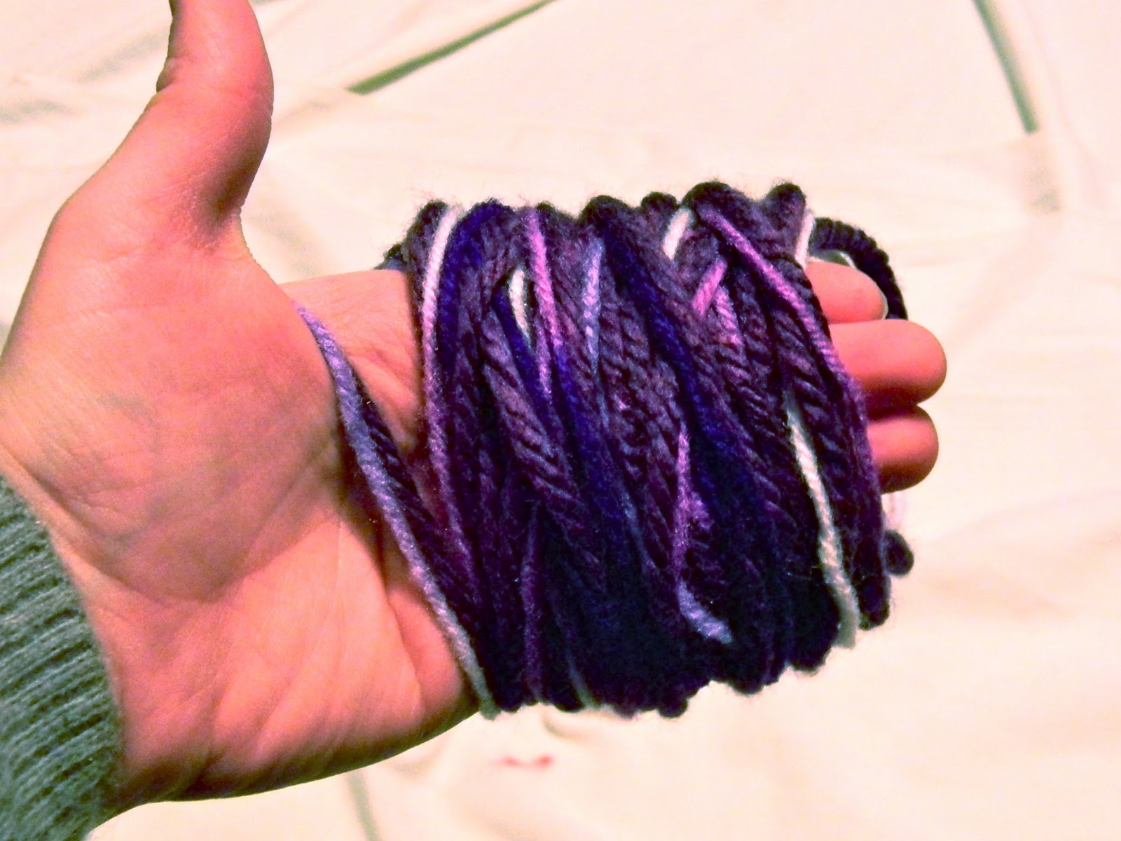 Wrap a bunch of yarn around your hand.