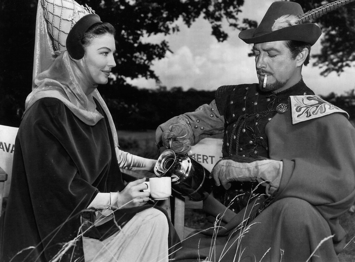 Robert Taylor is seen pouring a cup for Ava Gardner on the set of ...