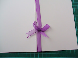 say it says: How to tie a ribbon round a card