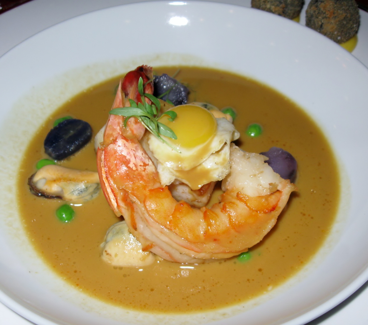 Chupe de mariscos with squid ink risotto croquetas : r/FoodPorn