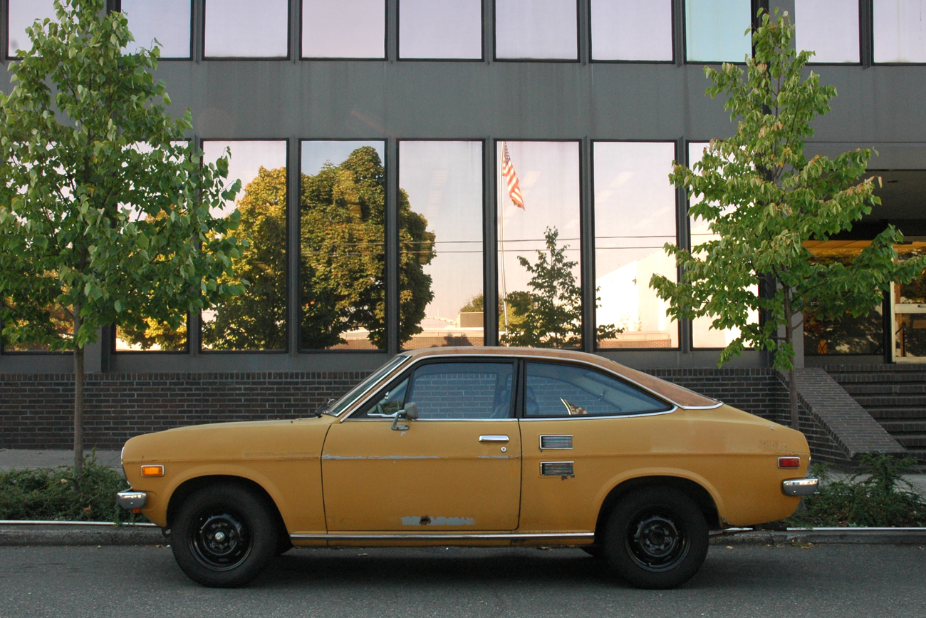 OLD PARKED CARS.: 1971 Datsun 1200 Fastback.