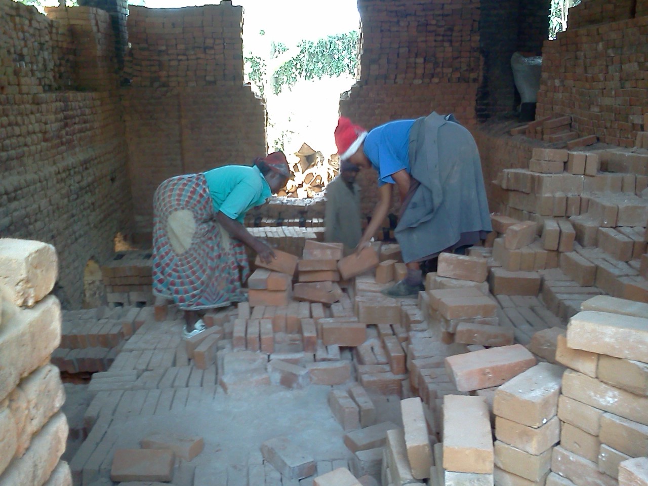 Alternative Building Construction : Making production clay bricks by hand.