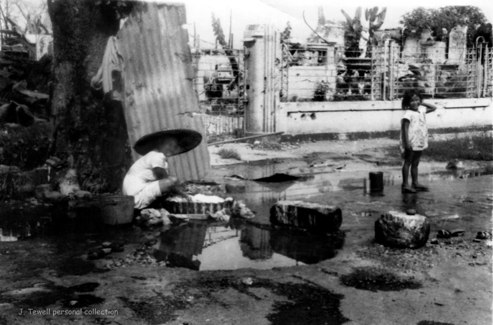 Mirrors of the Past : Filipina washing clothes in water filled shell ...