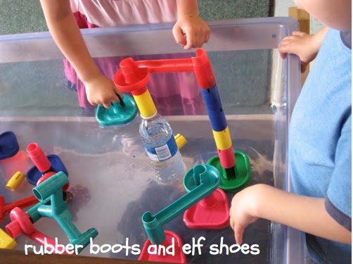 marble run + water = fun - rubber boots and elf shoes