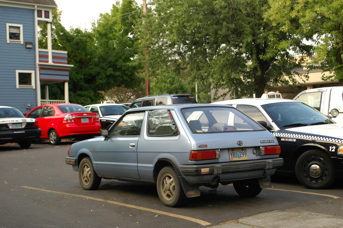 OLD PARKED CARS.: 1985 Subaru STD hatchback.