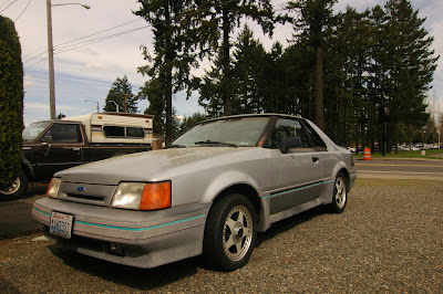 OLD PARKED CARS.: 1987 Ford EXP Sport Coupe.