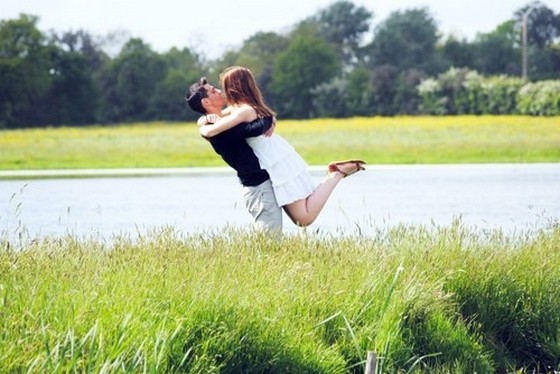 Hug couple cute teen lift girl grass | nineimages