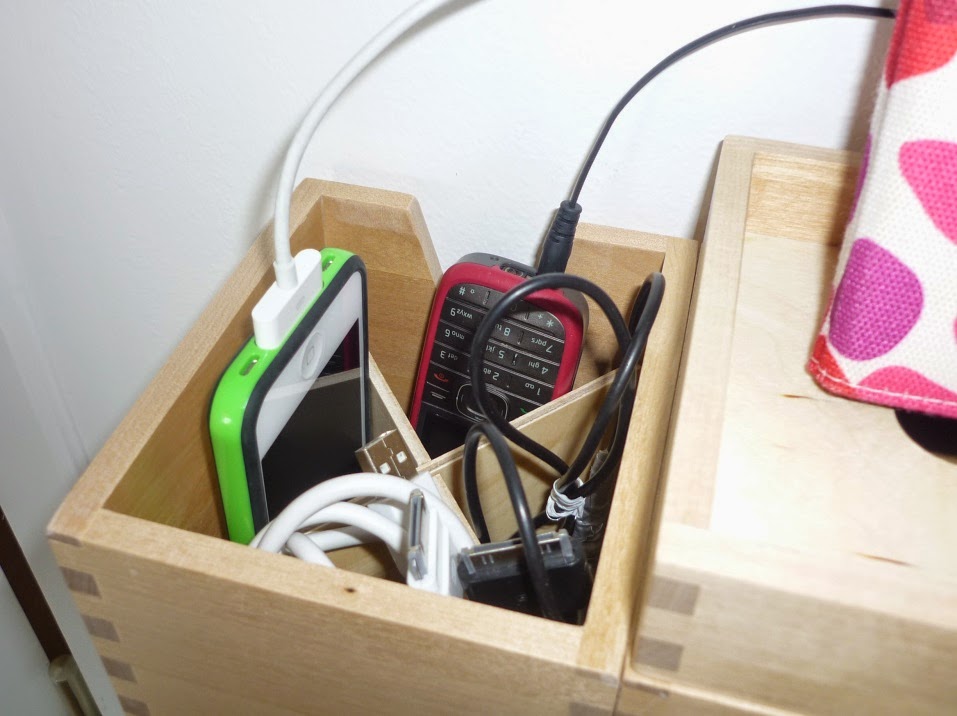 Wall-mounted charging station plus earphone/cable storage