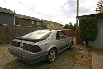 OLD PARKED CARS.: 1987 Ford EXP Sport Coupe.