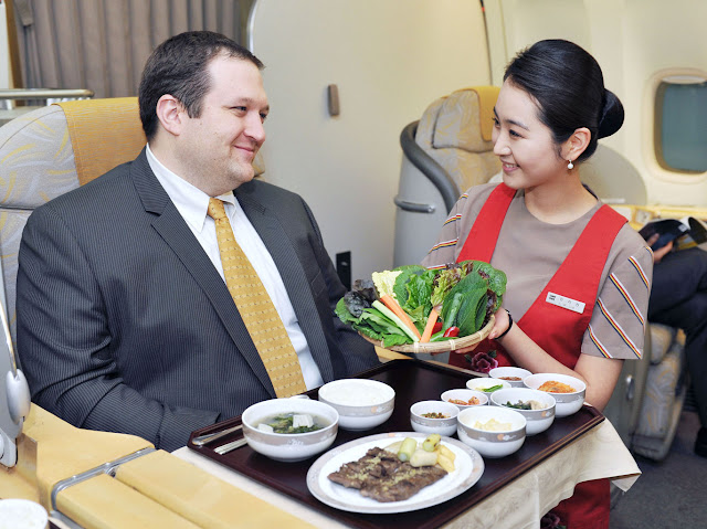 Stewardess Serves the Delicious Cabin Meal of Asiana Airlines