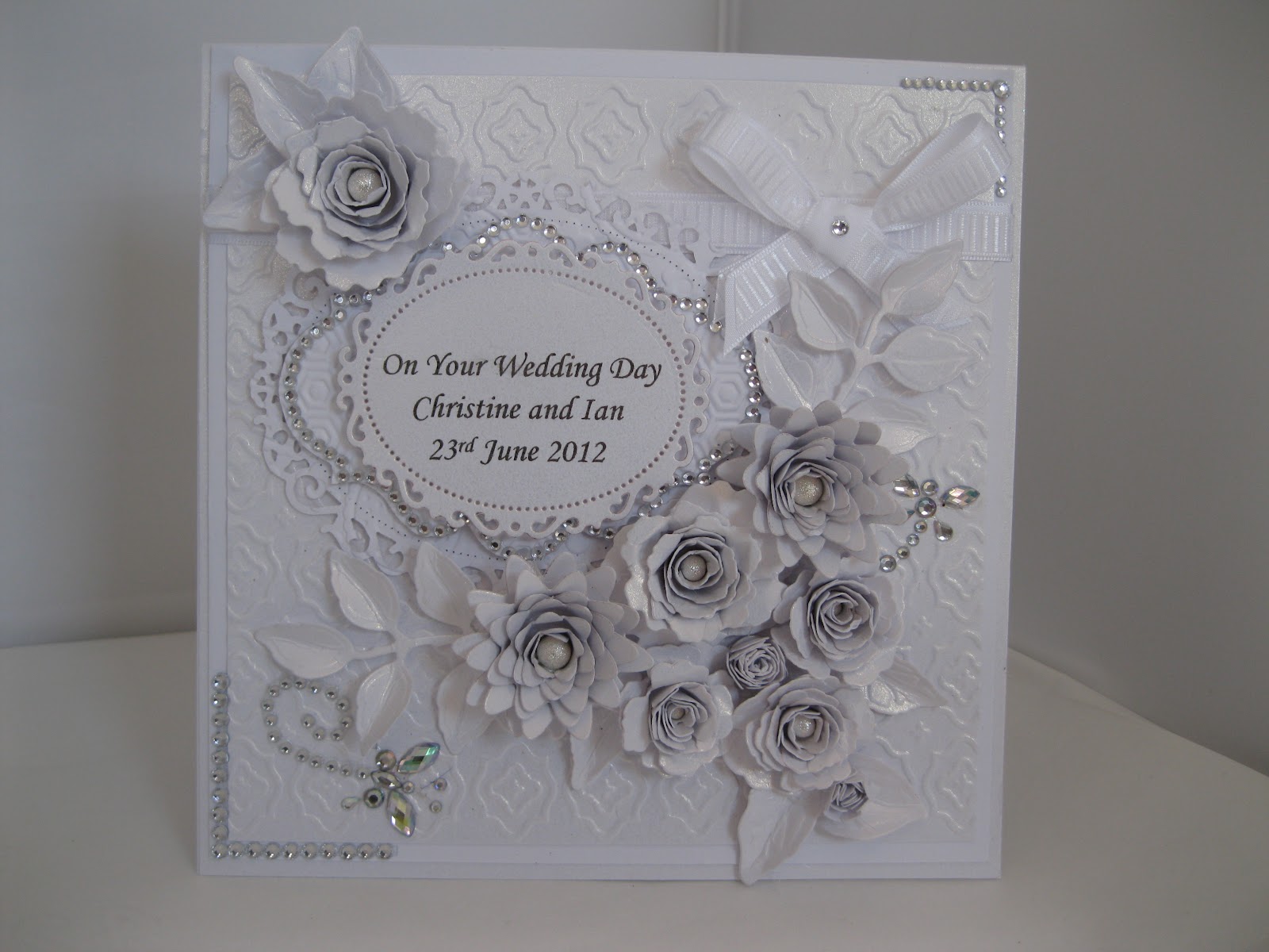 Flowers, Ribbons and Pearls: Silver and White Wedding Card.