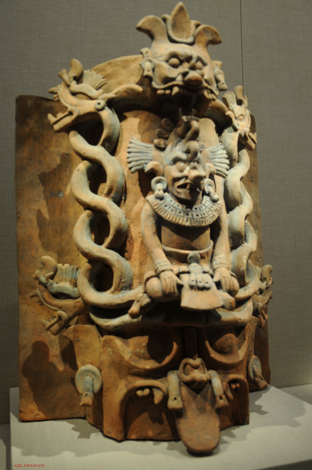 The smoking god L smoking, in a bas-relief of the Maya city of Palenque ...