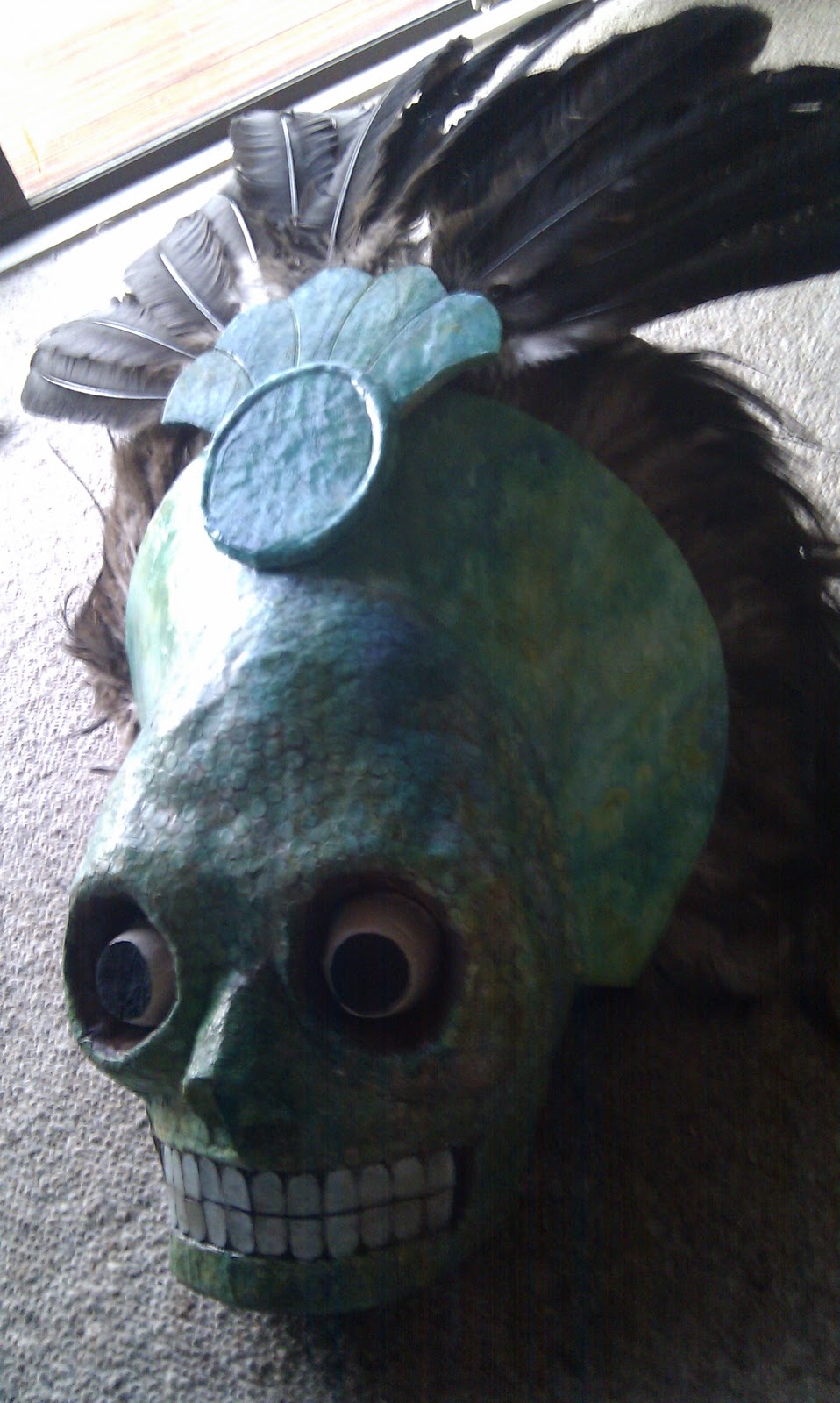 Mayan mask with feathers