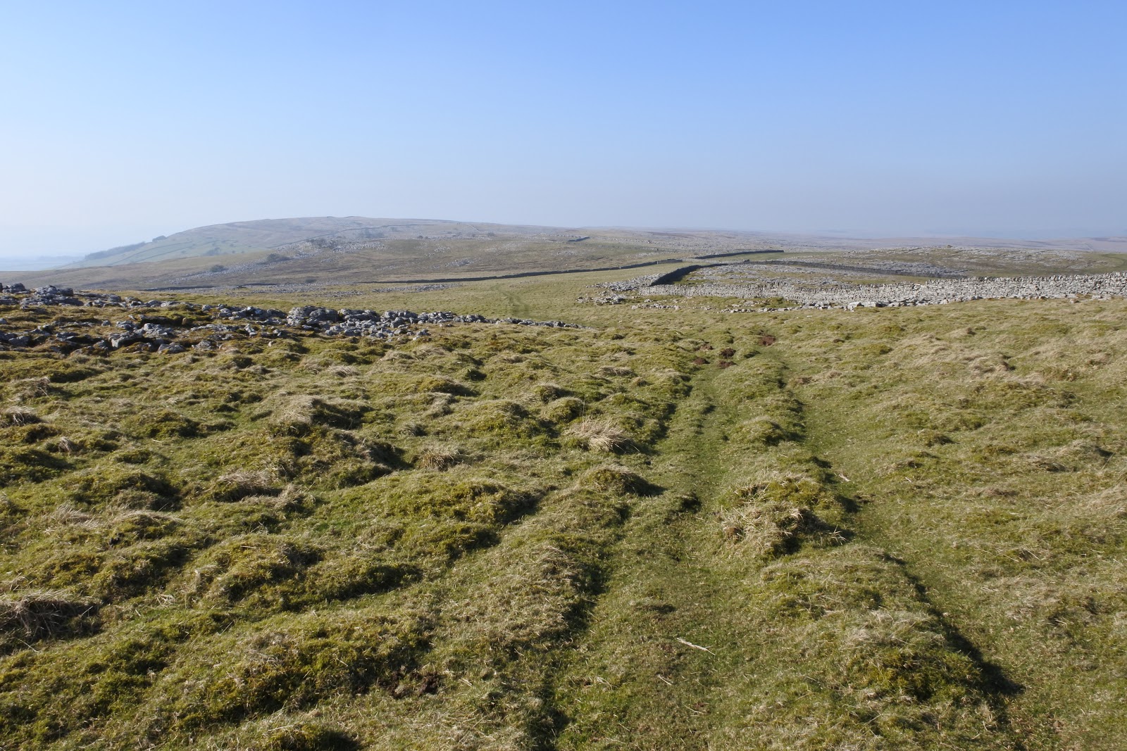 Great Asby limestone pavement, cairns and an OS trig point at the Knott ...
