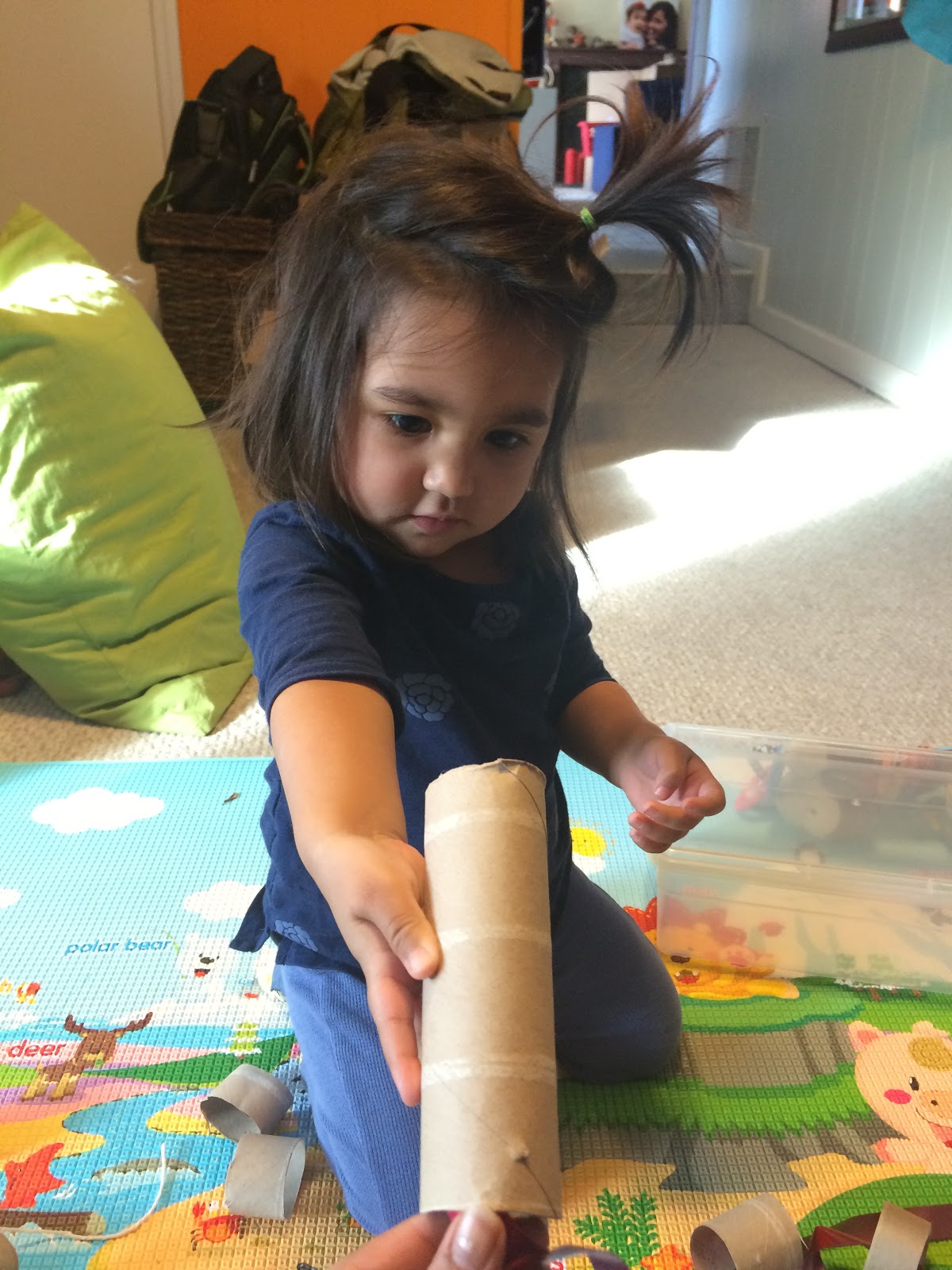 Raising a Mama: Toddler activity: threading toilet paper rolls