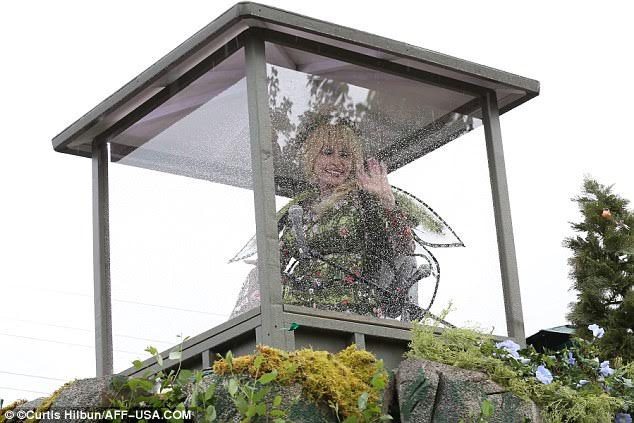 71-year-old country singer, Dolly Parton, glows in bright green during ...