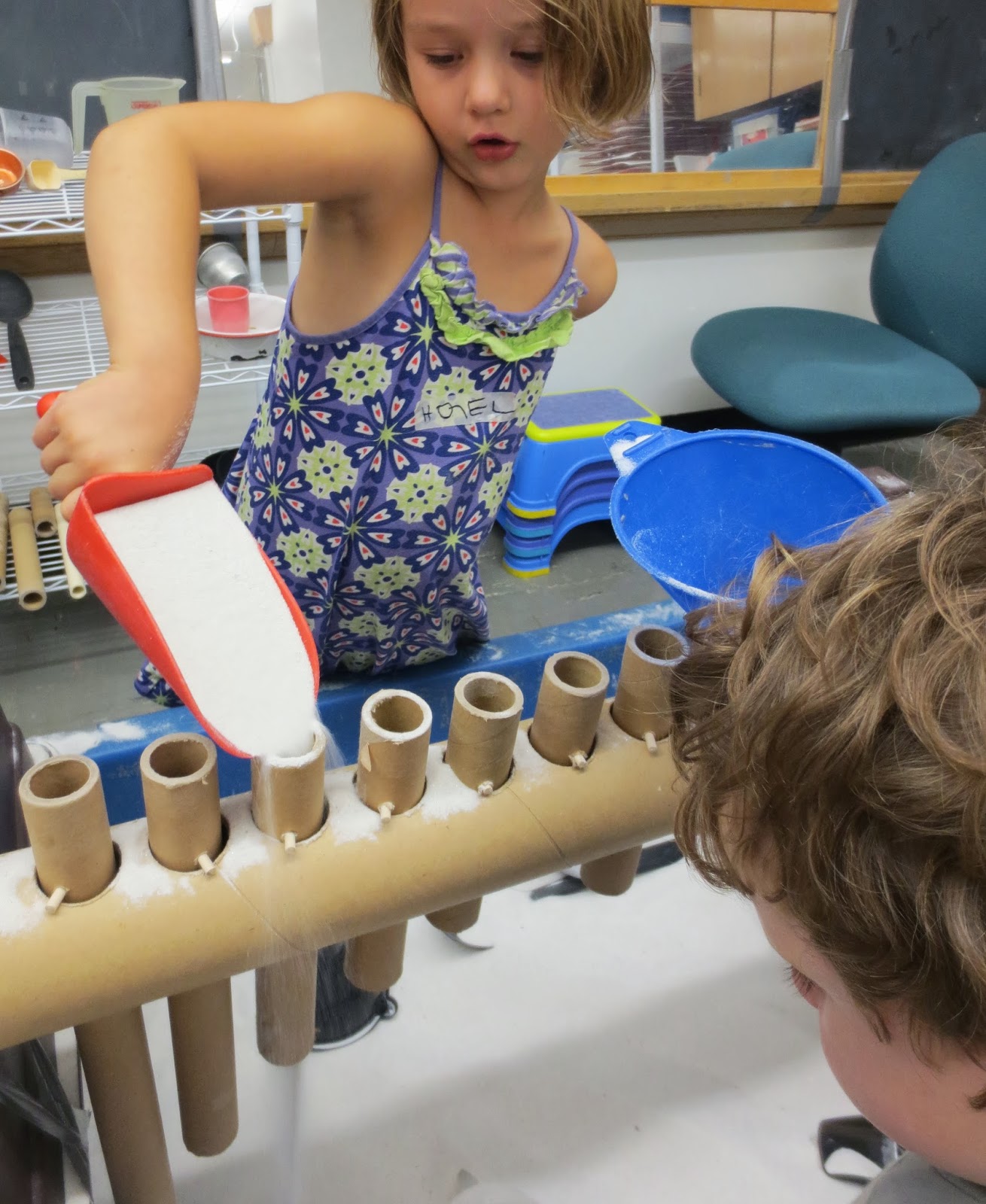 SAND AND WATER TABLES: CARDBOARD TUBES EMBEDDED IN A CARDBOARD TUBE